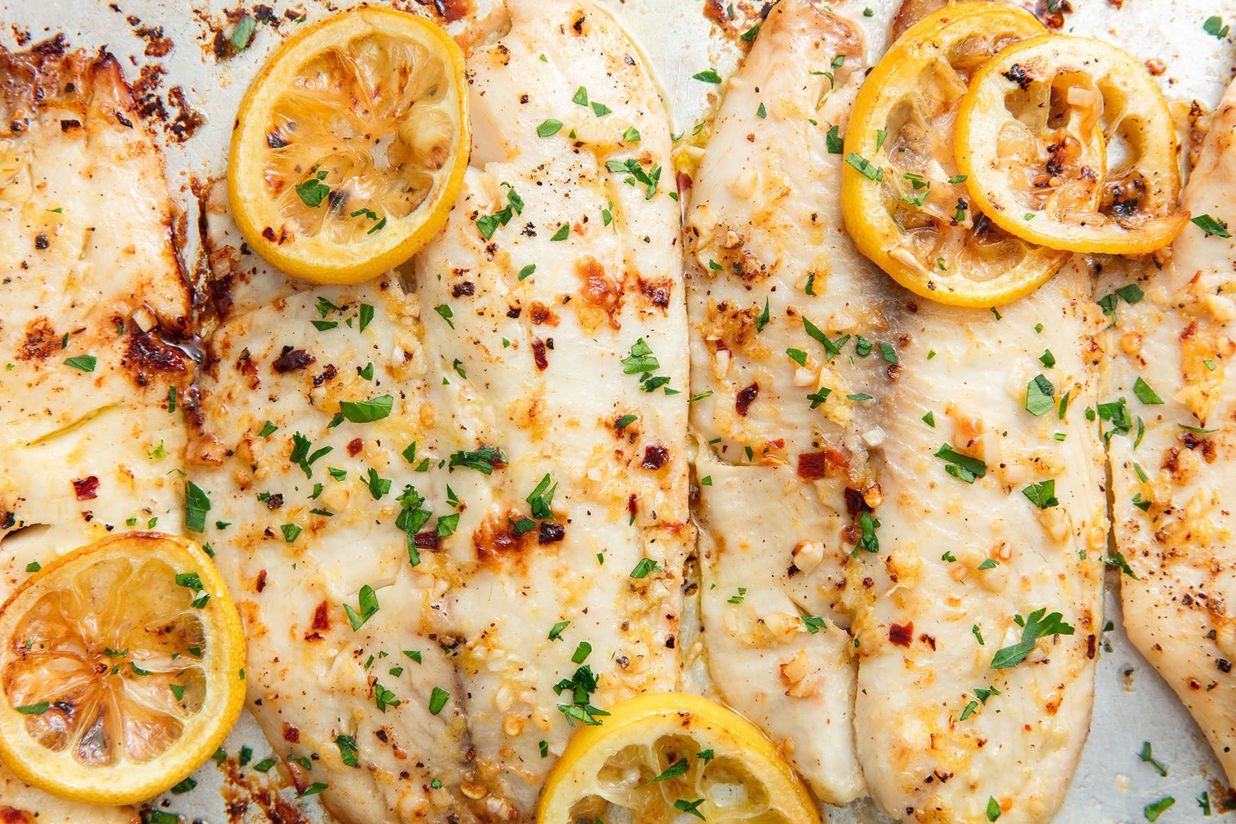 At what temperature is tilapia cooked through?