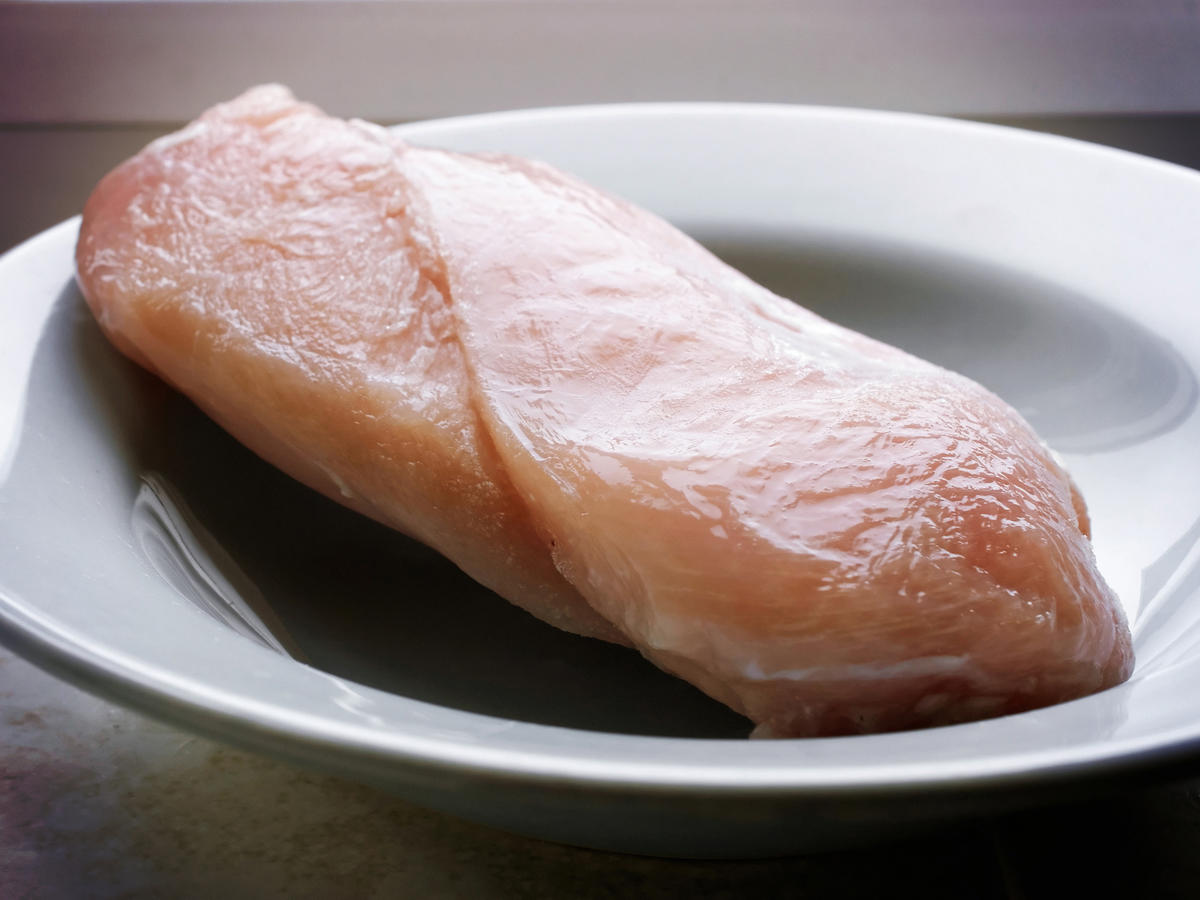 Can you cook raw chicken and frozen chicken together?