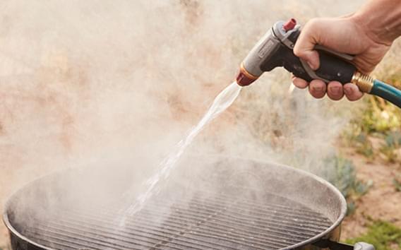 Can you pour water on charcoal grill?