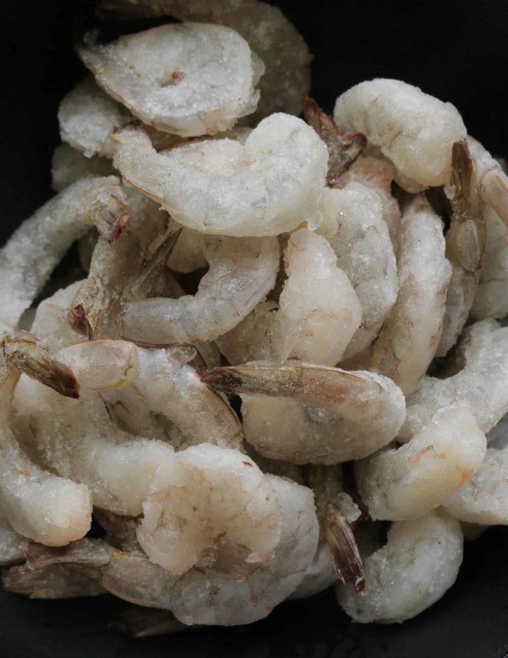 Can you run hot water over frozen shrimp?