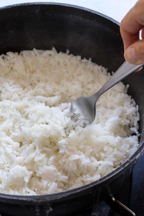 Do you cook rice before frying it?