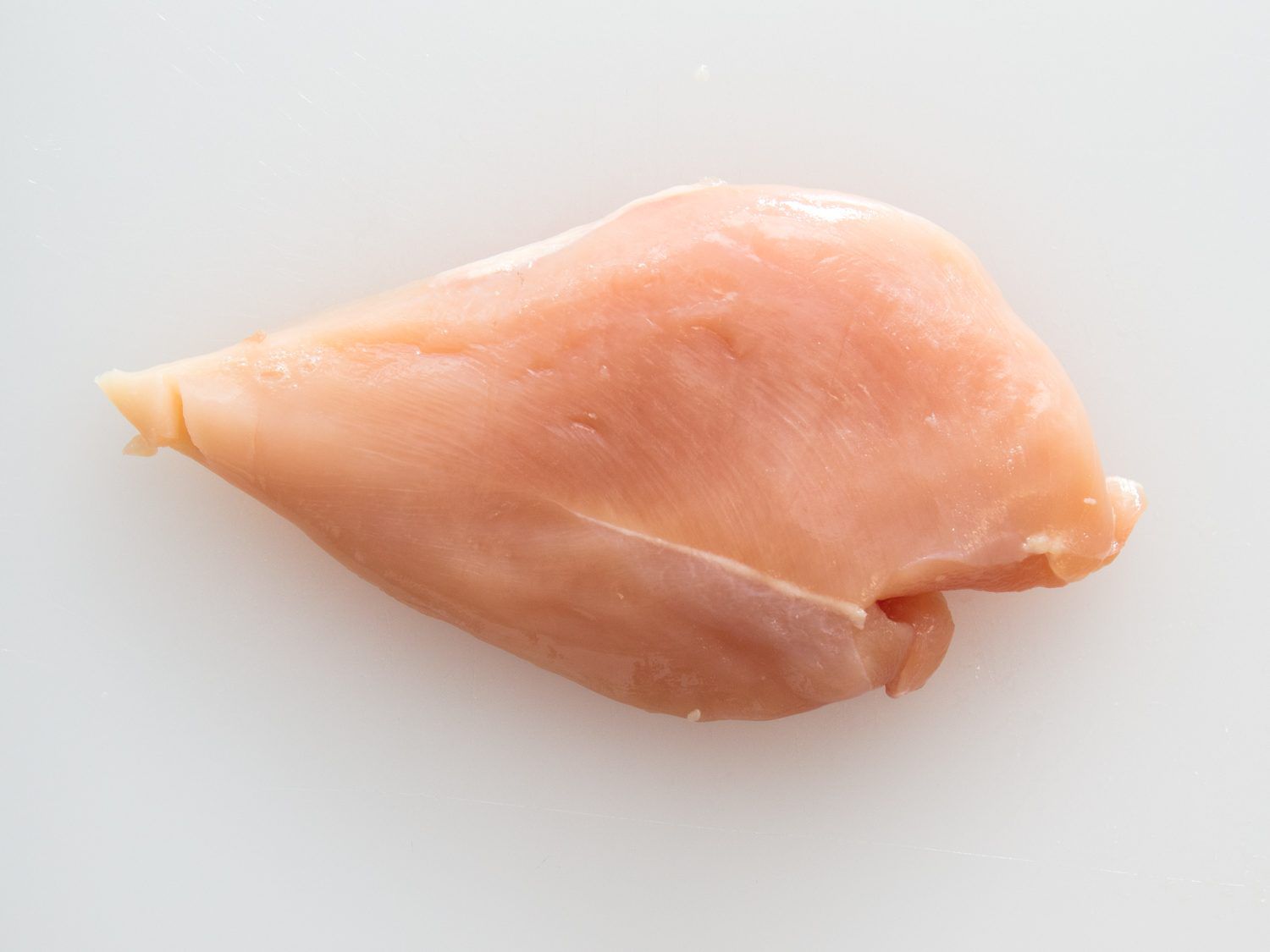 Do you cut chicken breast with or against the grain?