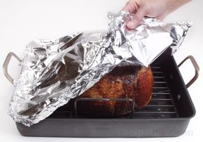 Do you put foil over ham in oven?