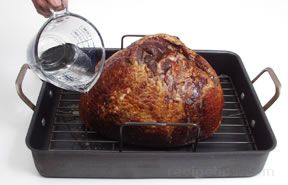 Do you put water in roasting pan when cooking ham?