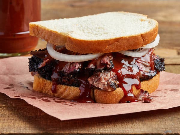 How do restaurants cook and serve brisket?