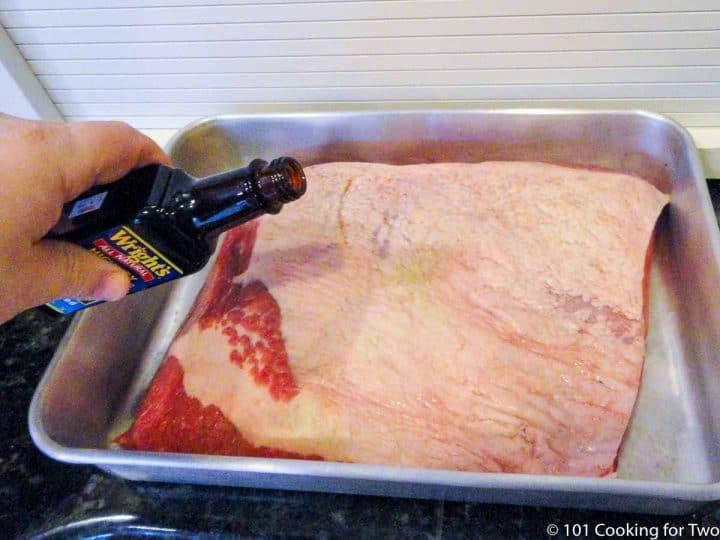 How do you add liquid to a brisket while cooking?