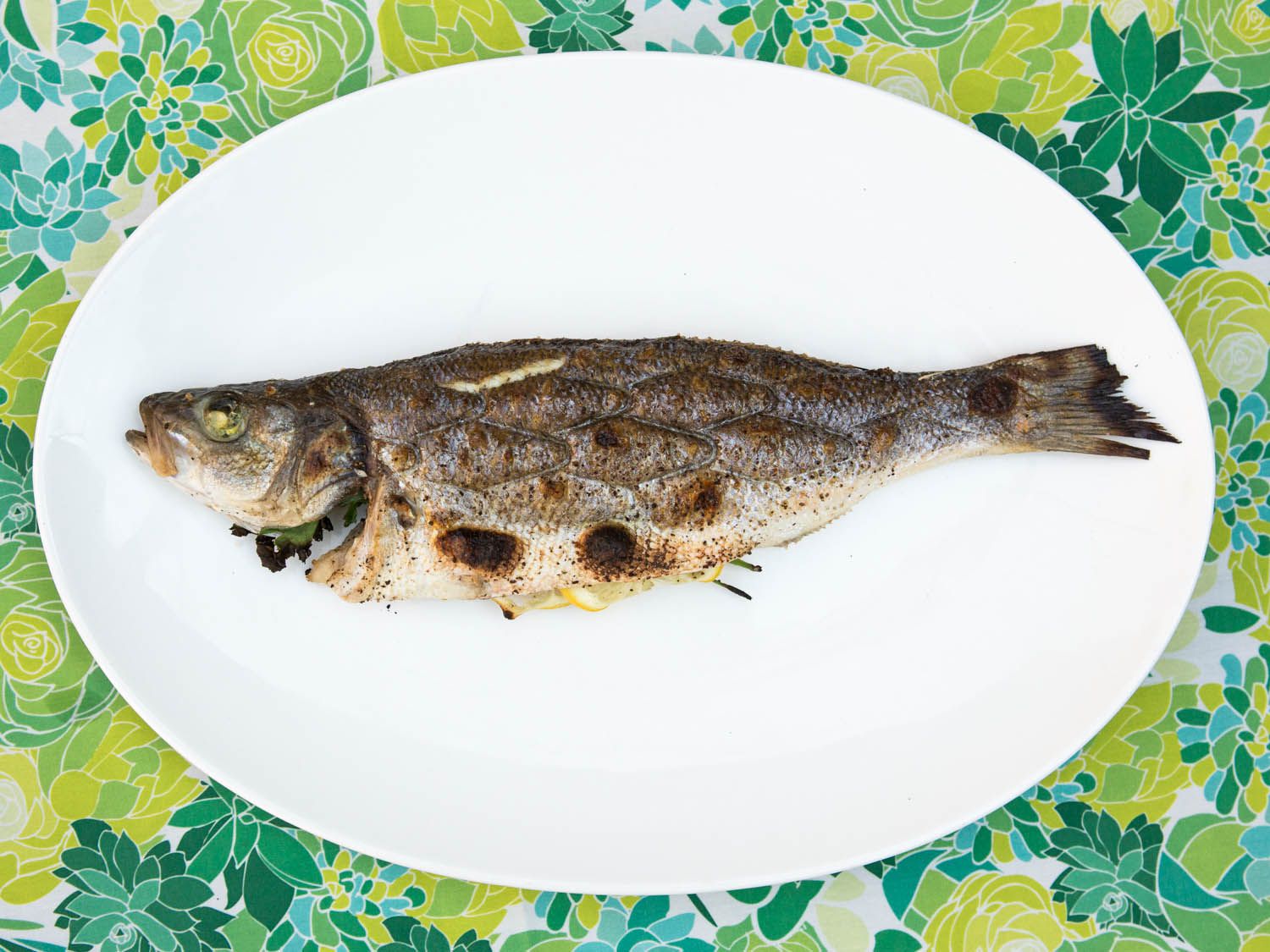 How do you carve a roasted fish?