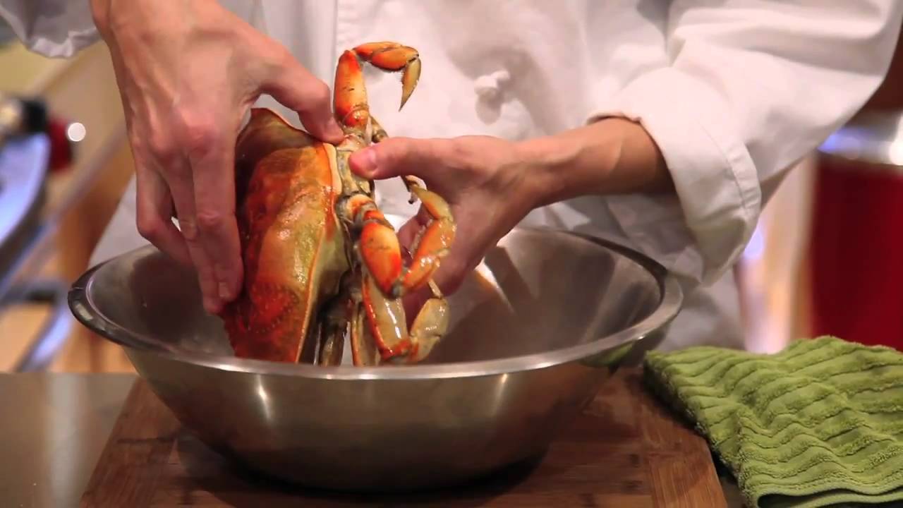 How do you clean and cook a whole crab?