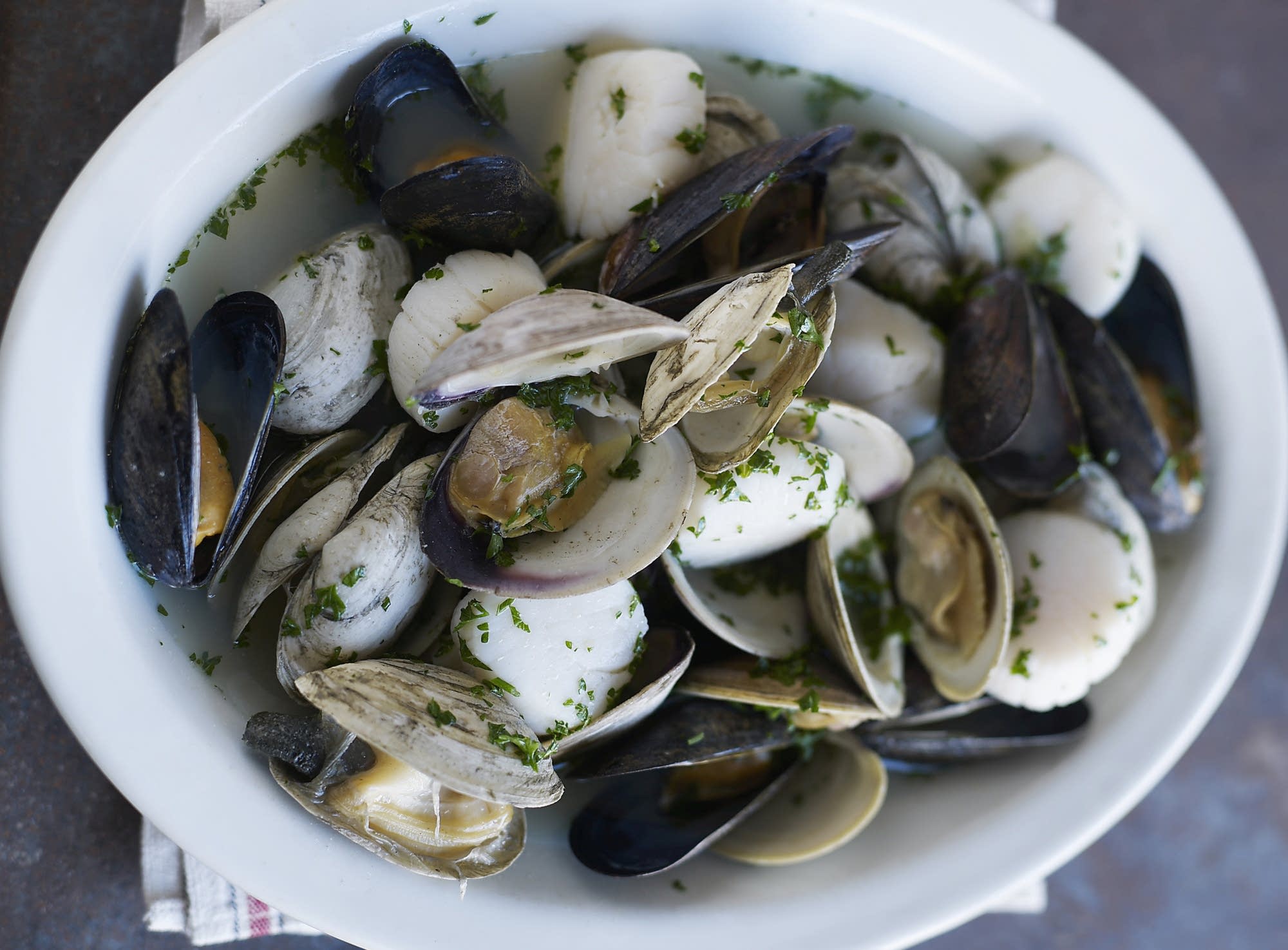 How do you clean clams and mussels before cooking?