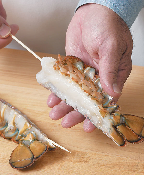 How do you cook lobster tails so they don't curl?