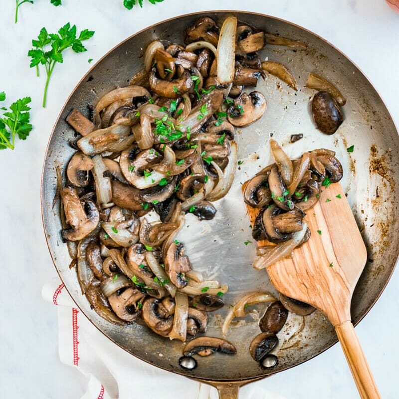 How do you cook mushrooms and onions in a pan?