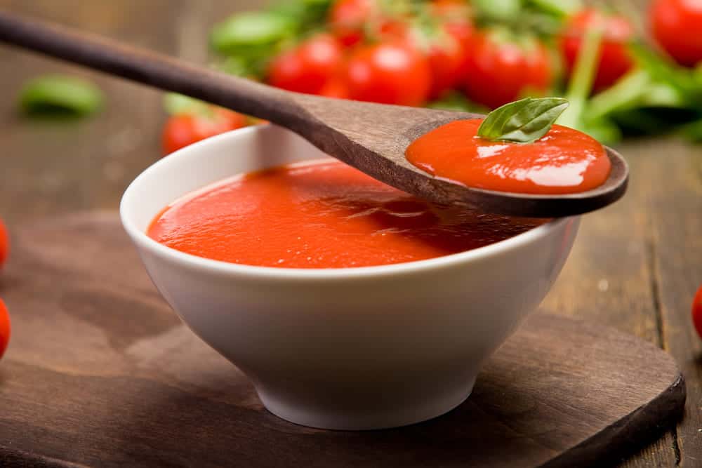 How do you cut the acidity in tomato basil soup?