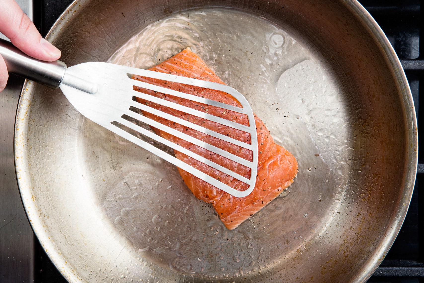 How do you flatten salmon when cooking it?