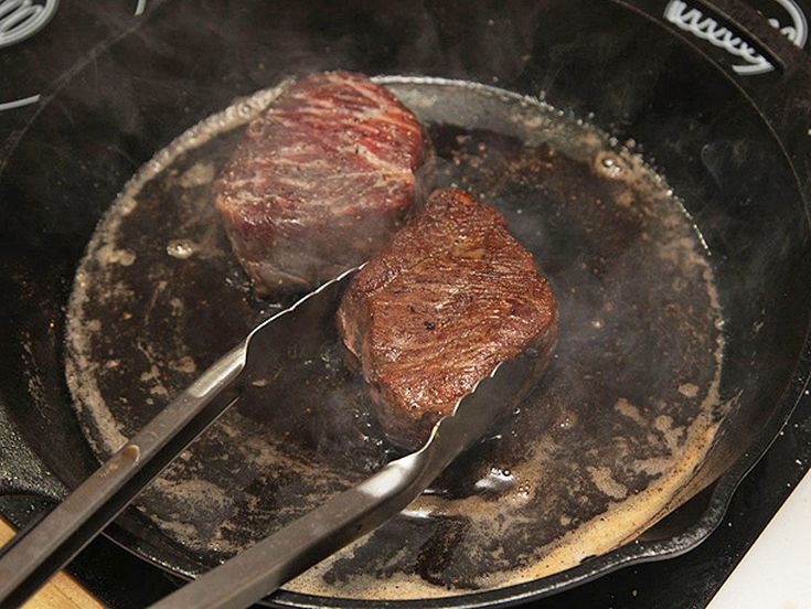 How do you flip a ribeye steak on the grill?
