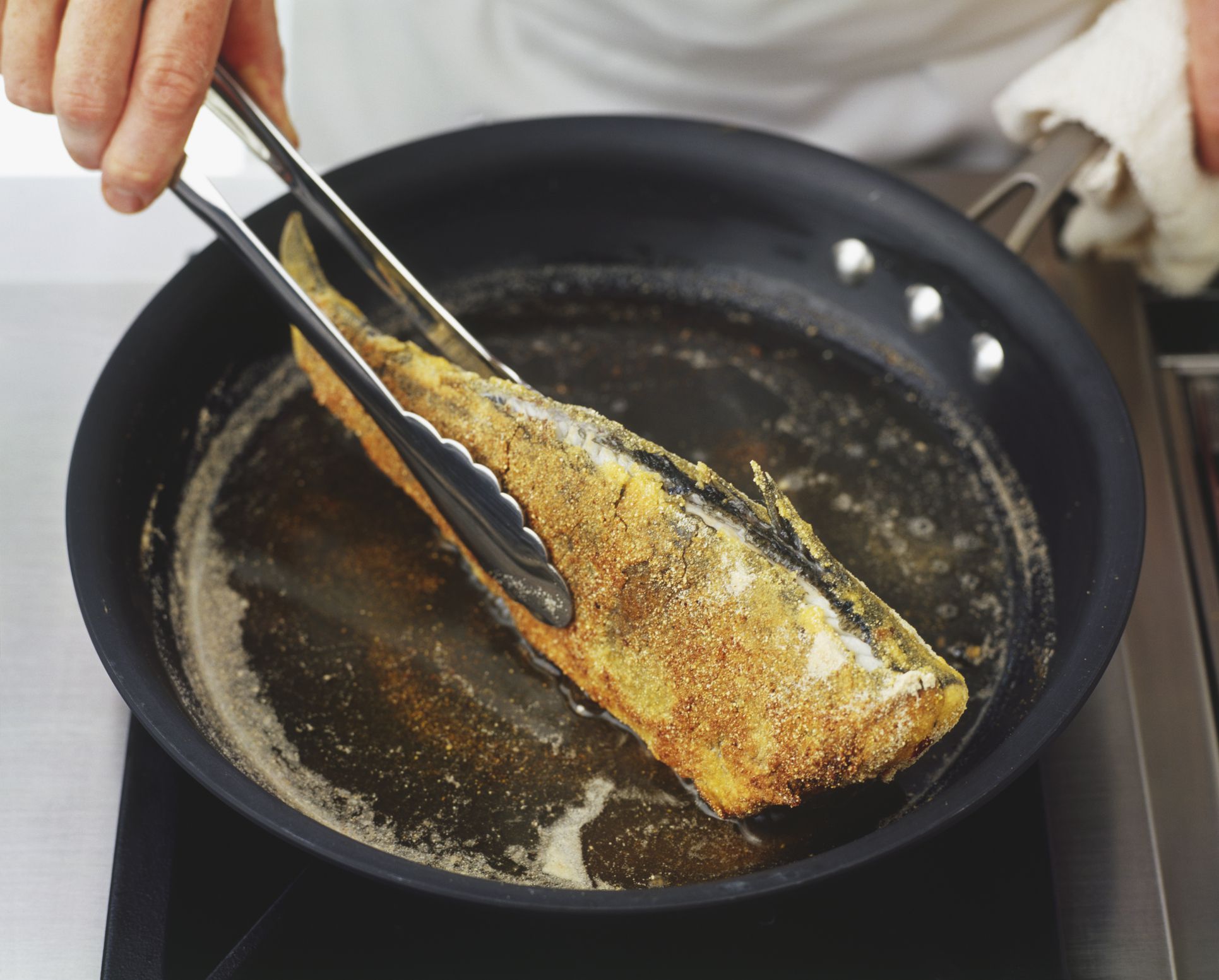 How do you fry fish in a small amount of oil?
