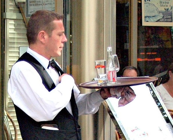 How do you greet a waiter in French?