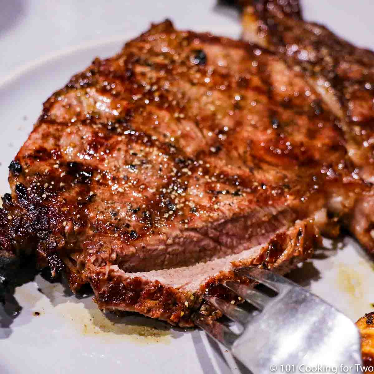 How do you grill a thick ribeye steak on a gas grill?