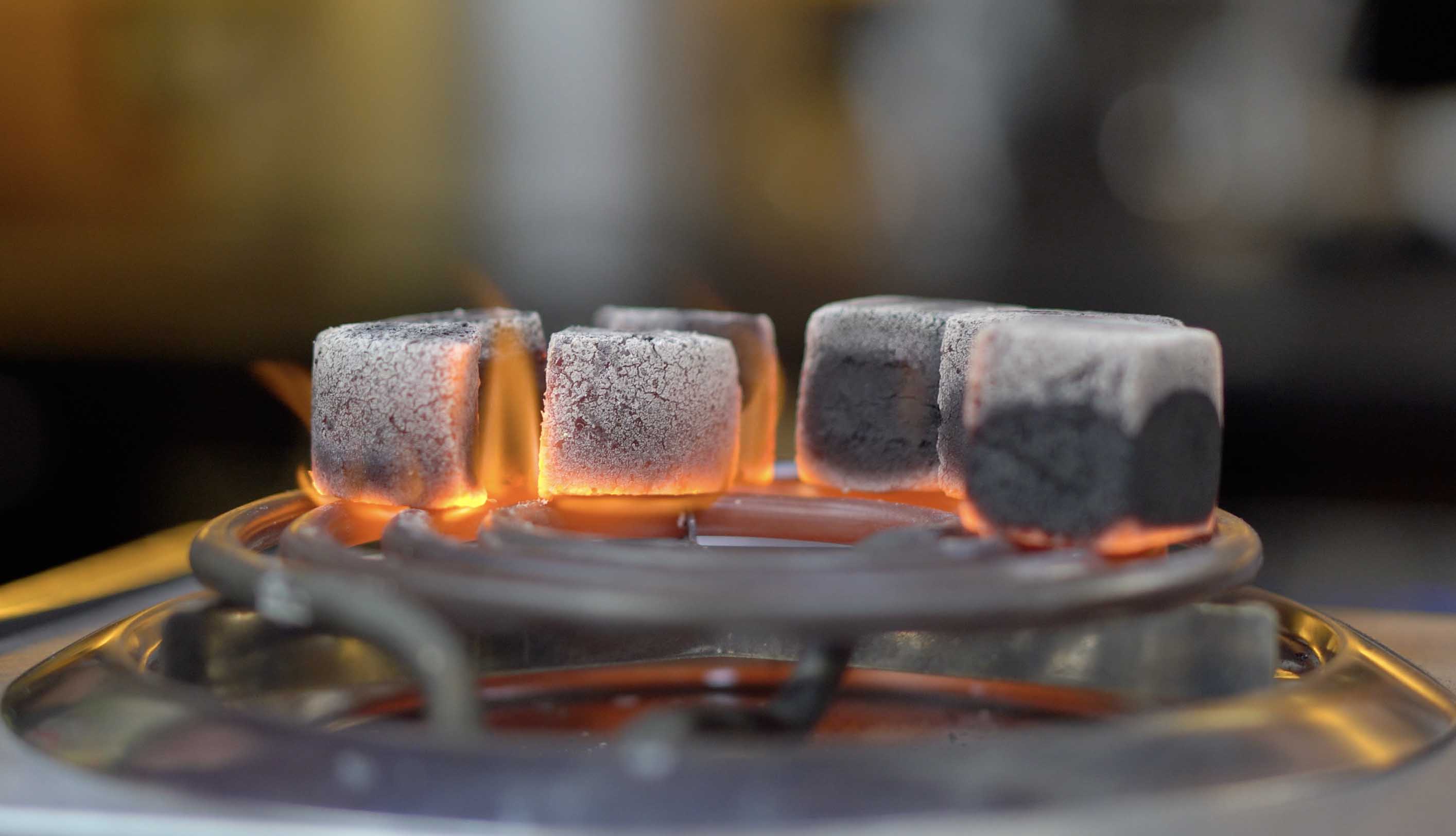 How do you heat up hot coals?
