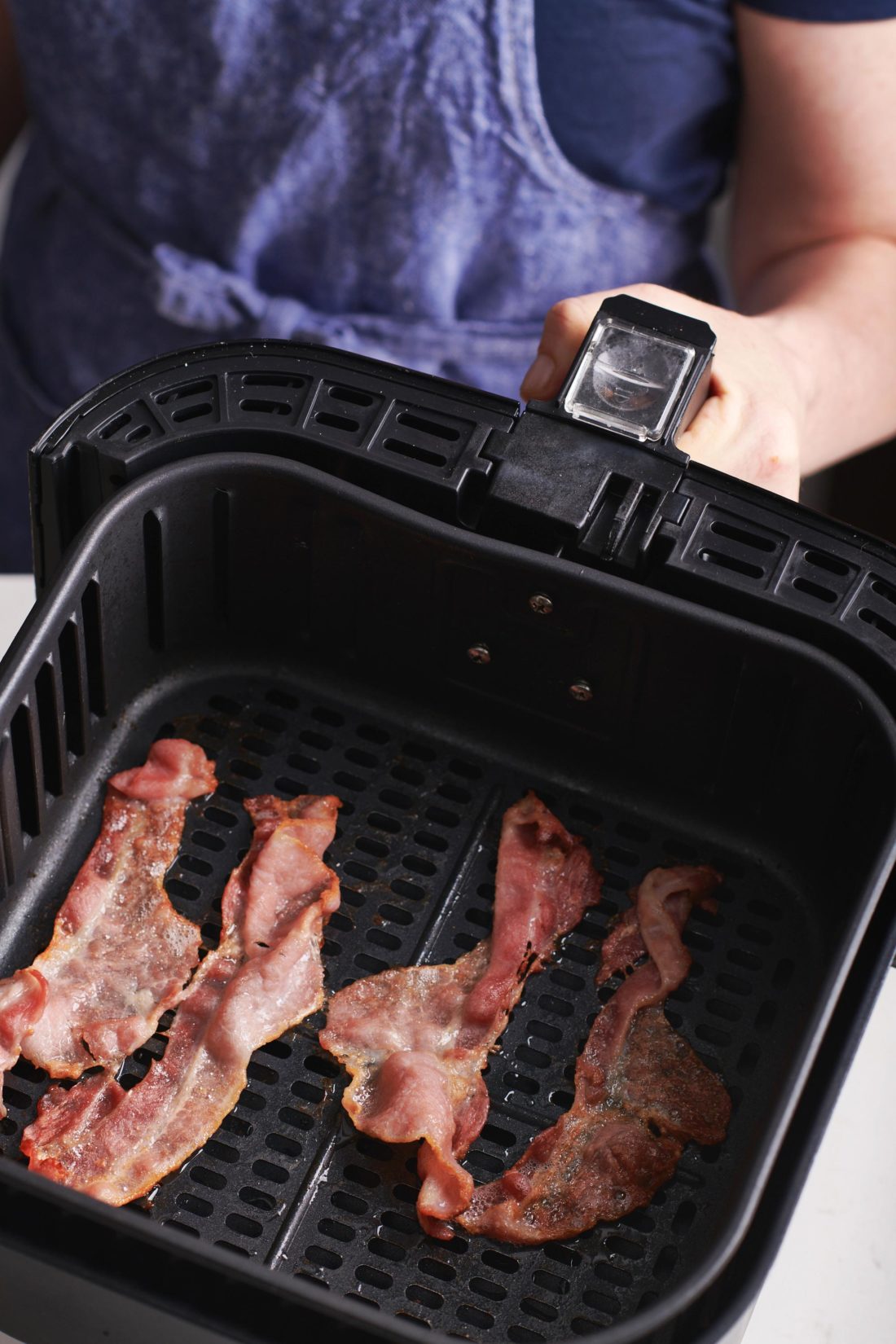 How do you keep bacon from shrinking in an air fryer?