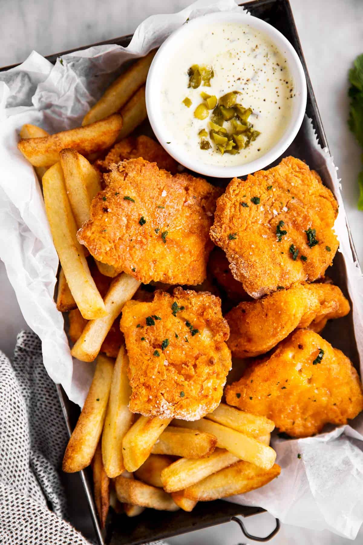 How do you keep battered fish crispy in the oven?