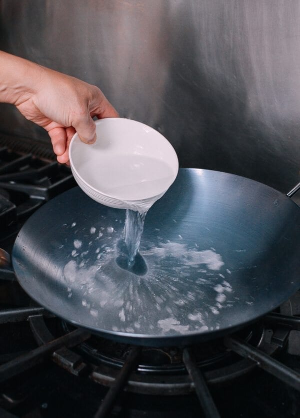 How do you keep food from sticking to a wok?