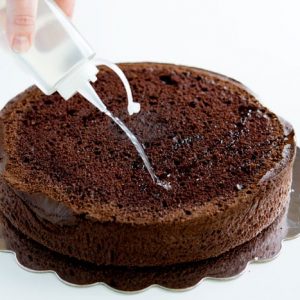 How do you moisten a cake before baking?