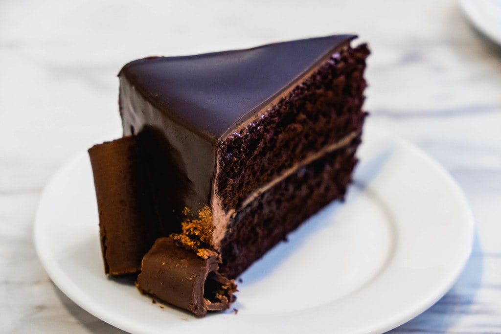 How do you moisten a dry chocolate cake before baking?