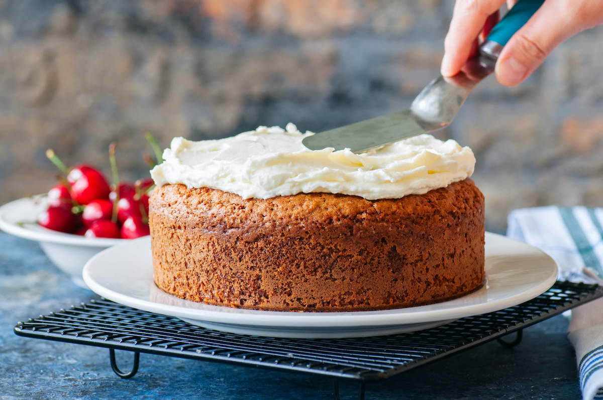 How do you moisten a dry frosted cake?