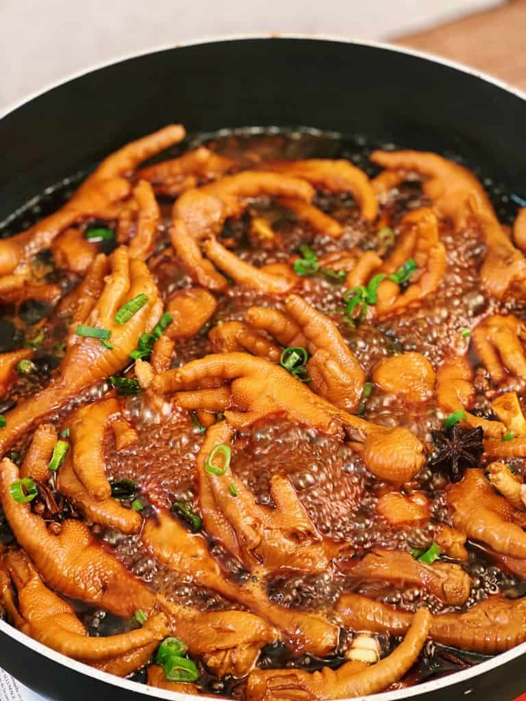 How do you prepare chicken feet before cooking?