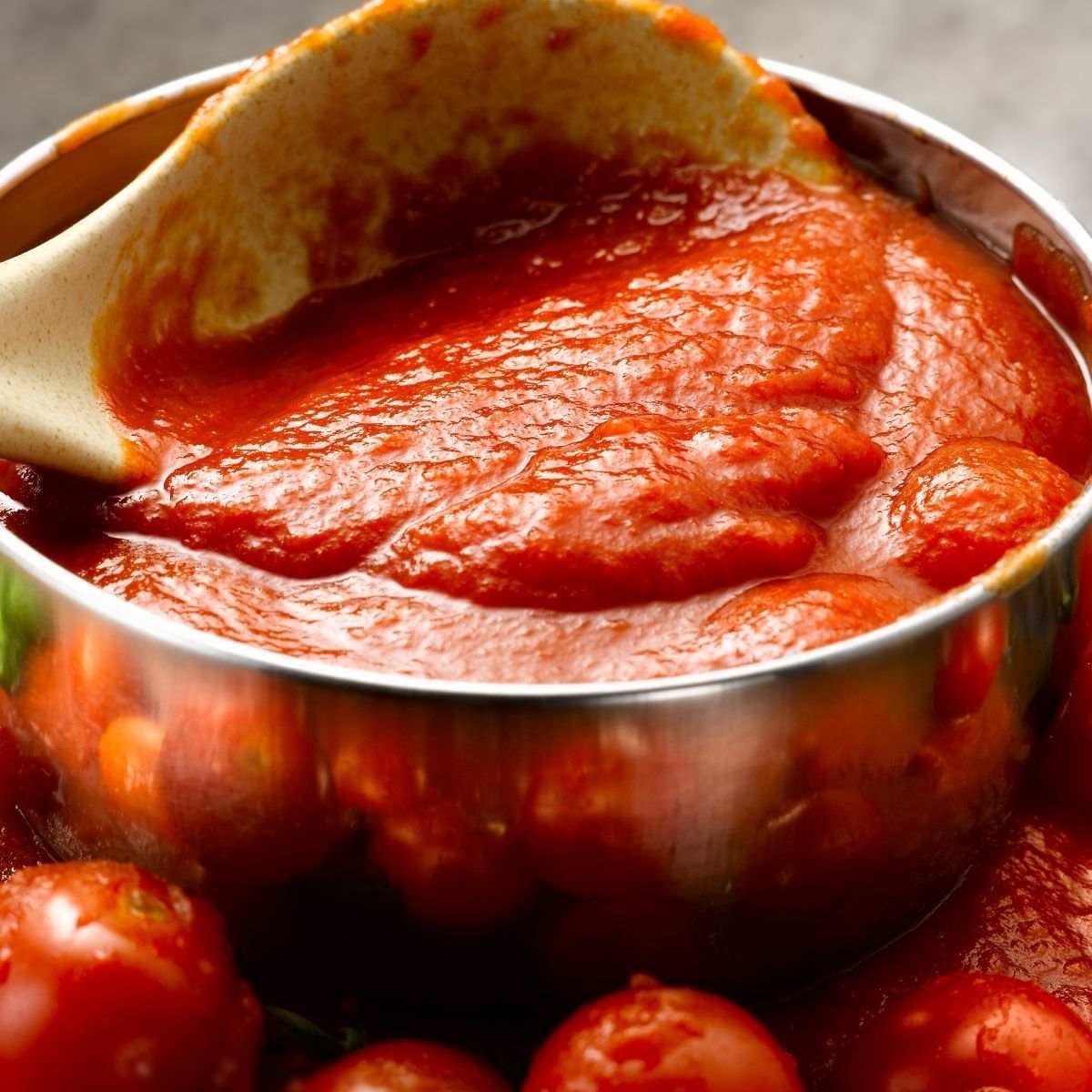 How do you reduce the acidity in tomato soup?