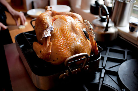 How do you reheat a cooked turkey without drying it out?