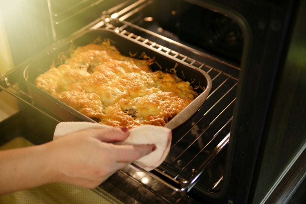 How do you reheat meat in the oven without drying it out?