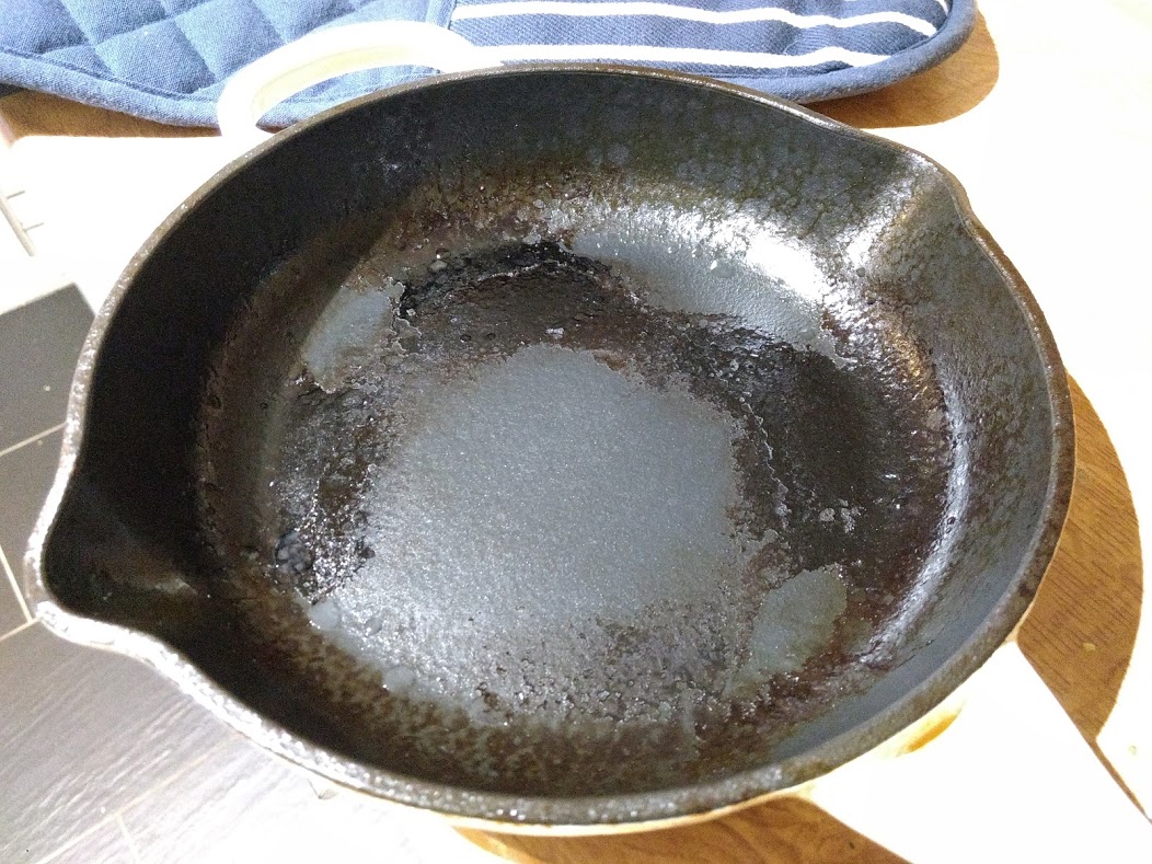 How do you remove baked on oil from cast iron?