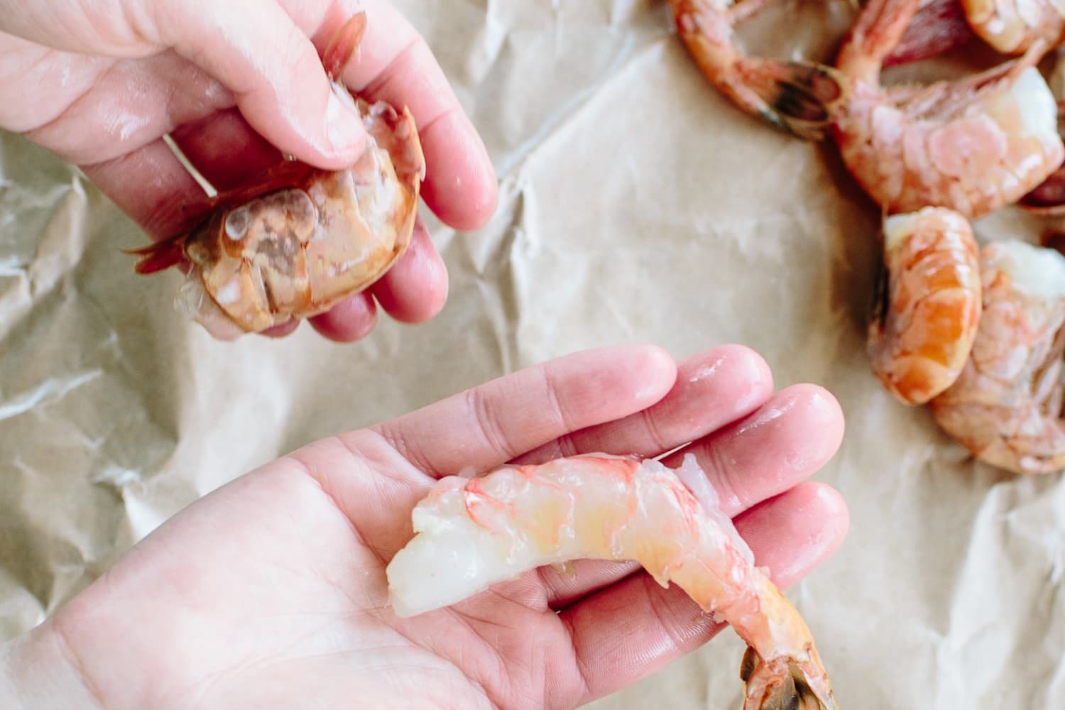 How do you remove the shell from raw shrimp?