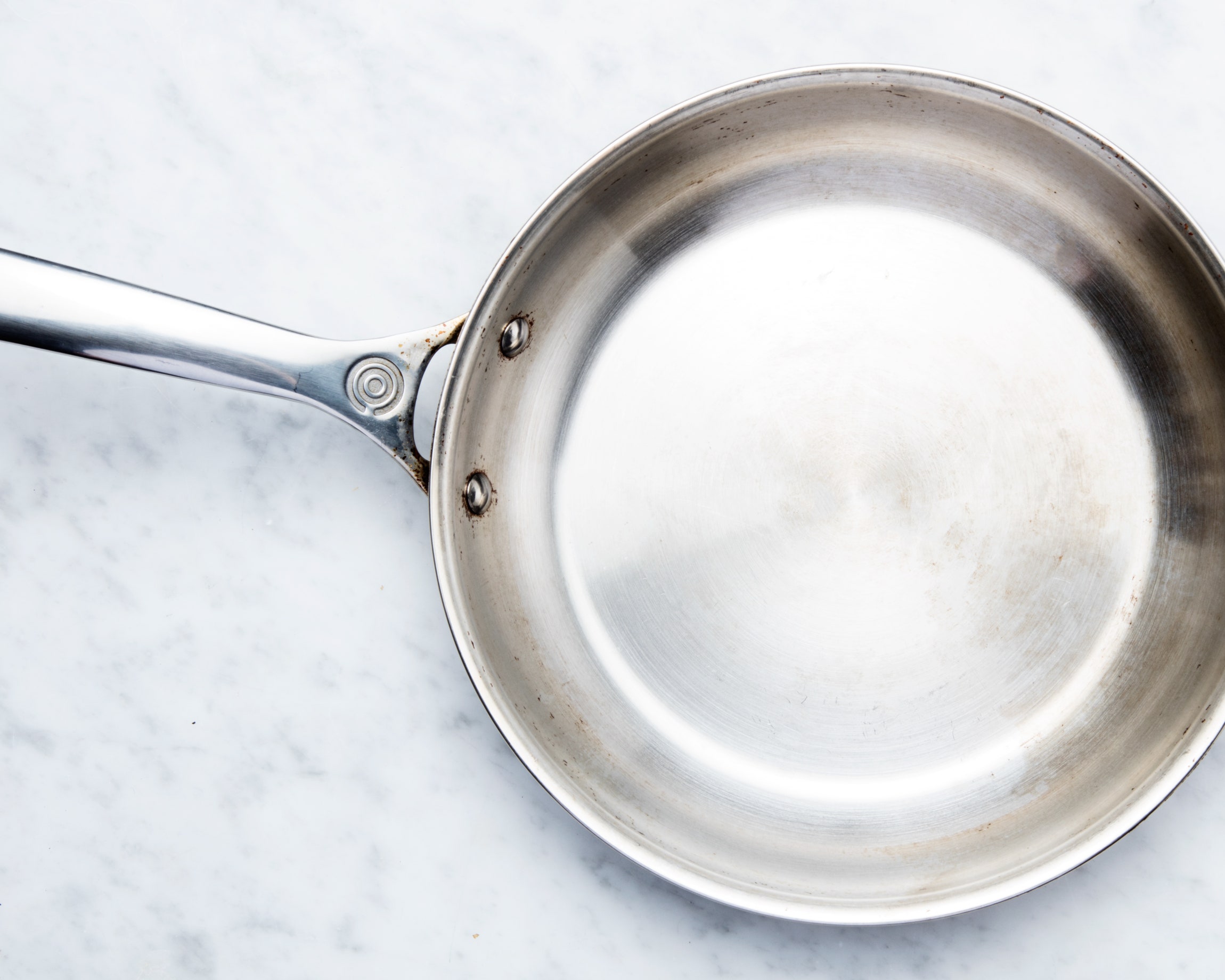 How do you season a stainless steel pan so it doesn't stick?