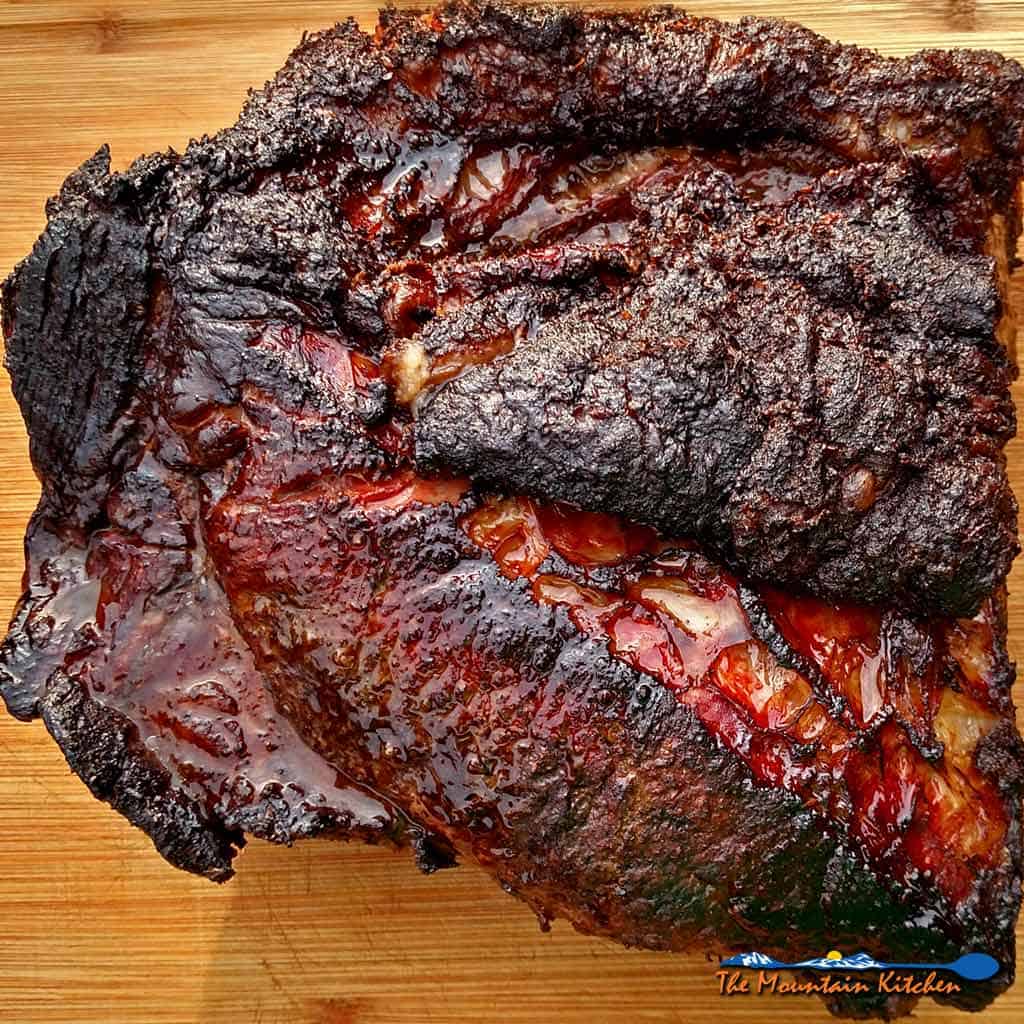 How do you slow cook brisket on coals?