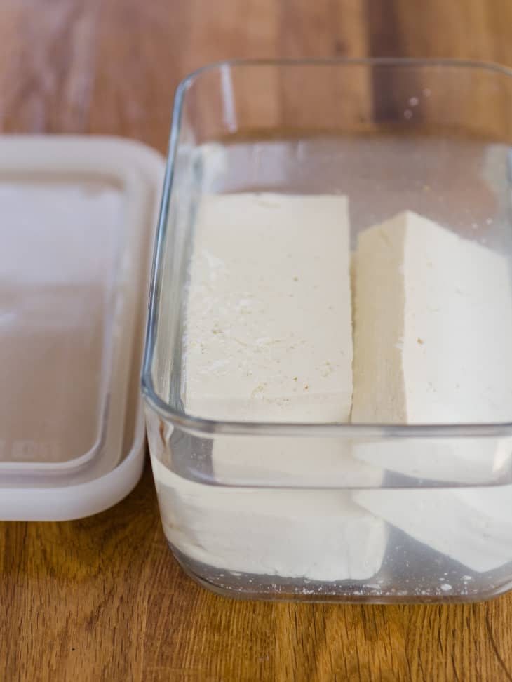 How do you store uncooked tofu in the fridge?