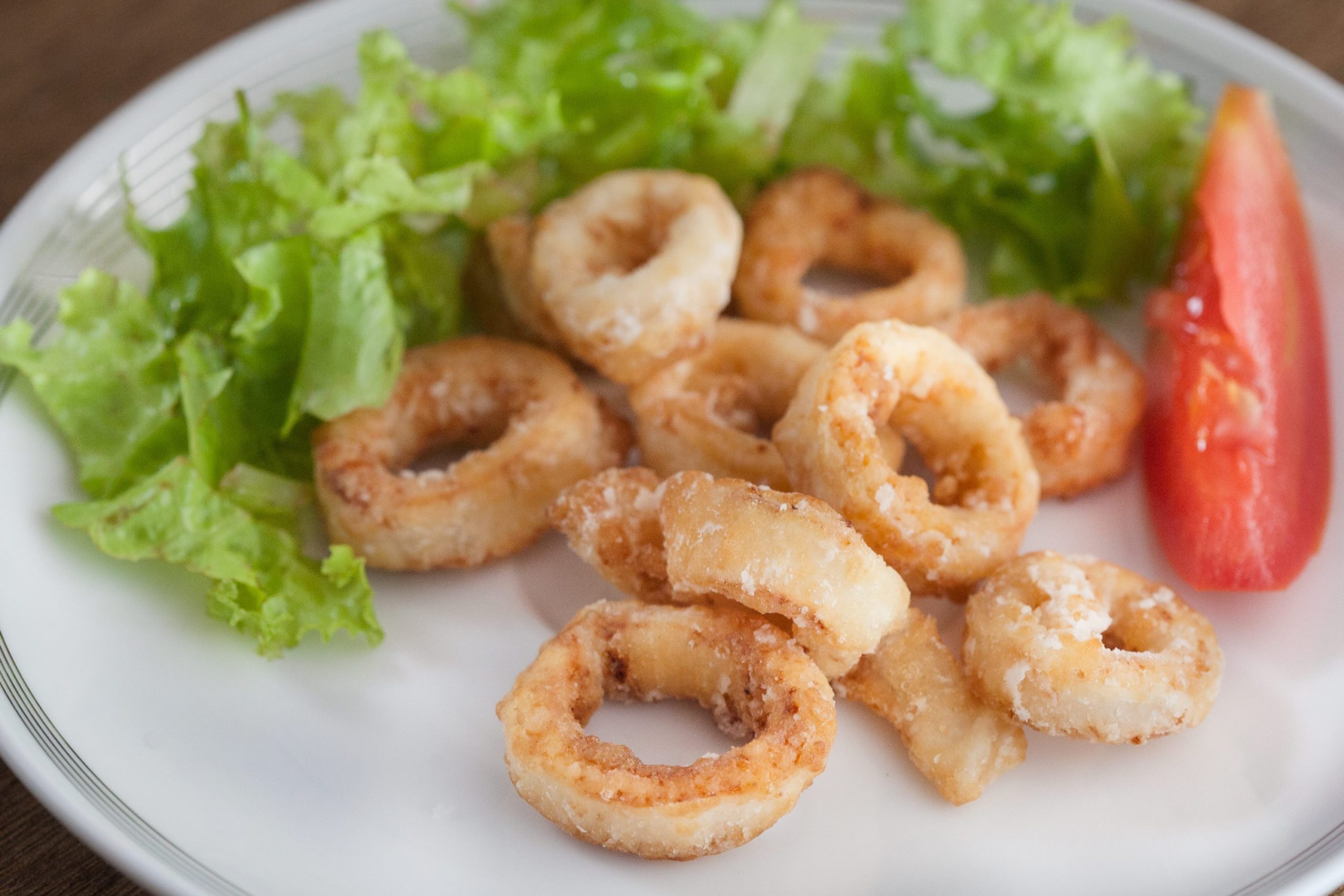 How do you tenderize calamari before frying?