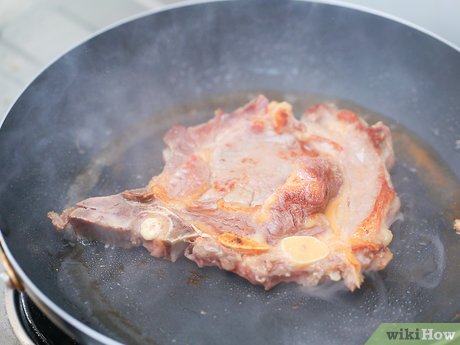 How do you tenderize pork chops before frying them?