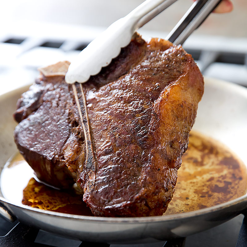 How do you warm up steak before cooking?