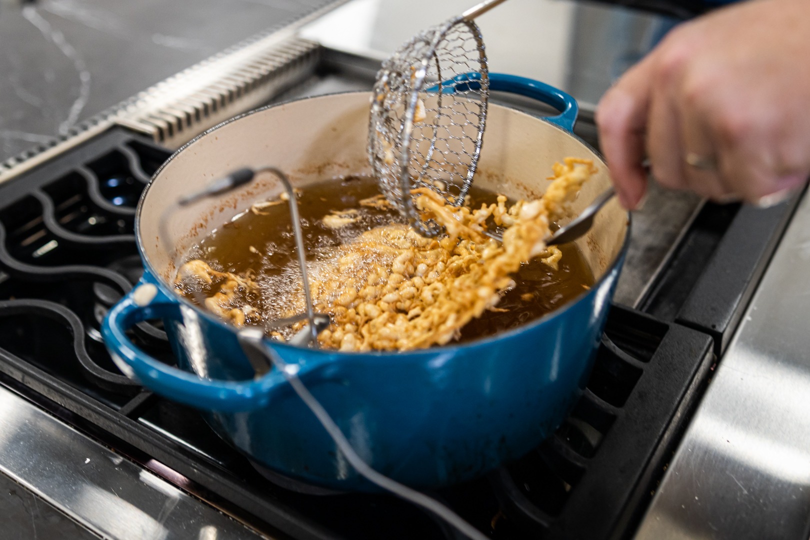 How hot should the oil be to cook funnel cakes?