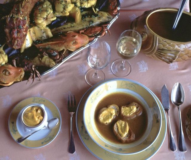 How is bouillabaisse traditionally served?