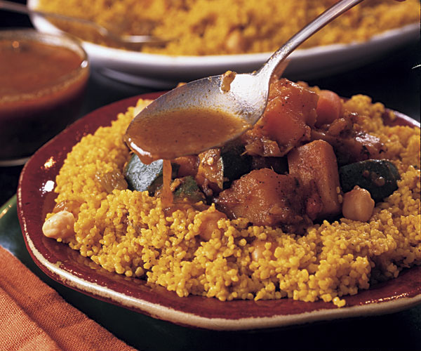 How is couscous traditionally cooked?