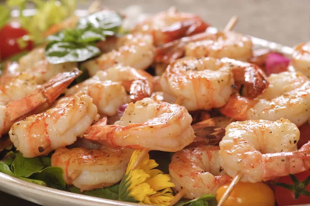 How long can cooked shrimp be left unrefrigerated?