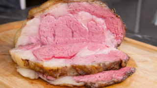 How long should prime rib roast sit at room temperature before cooking it?