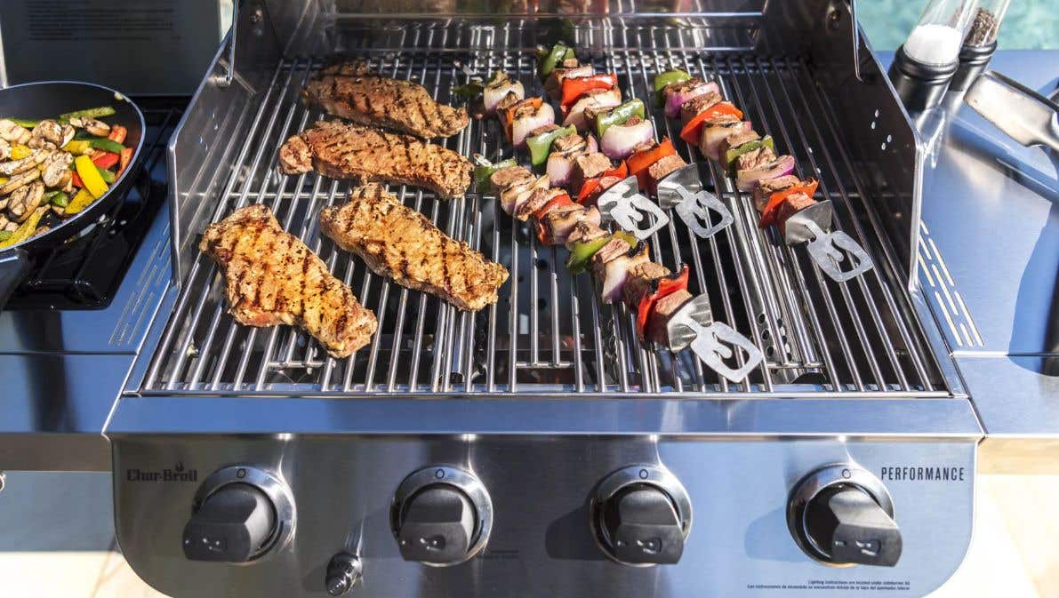 How long should you heat up a gas grill before cooking?