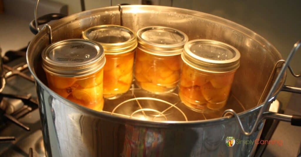 How much water should cover the jars when canning?