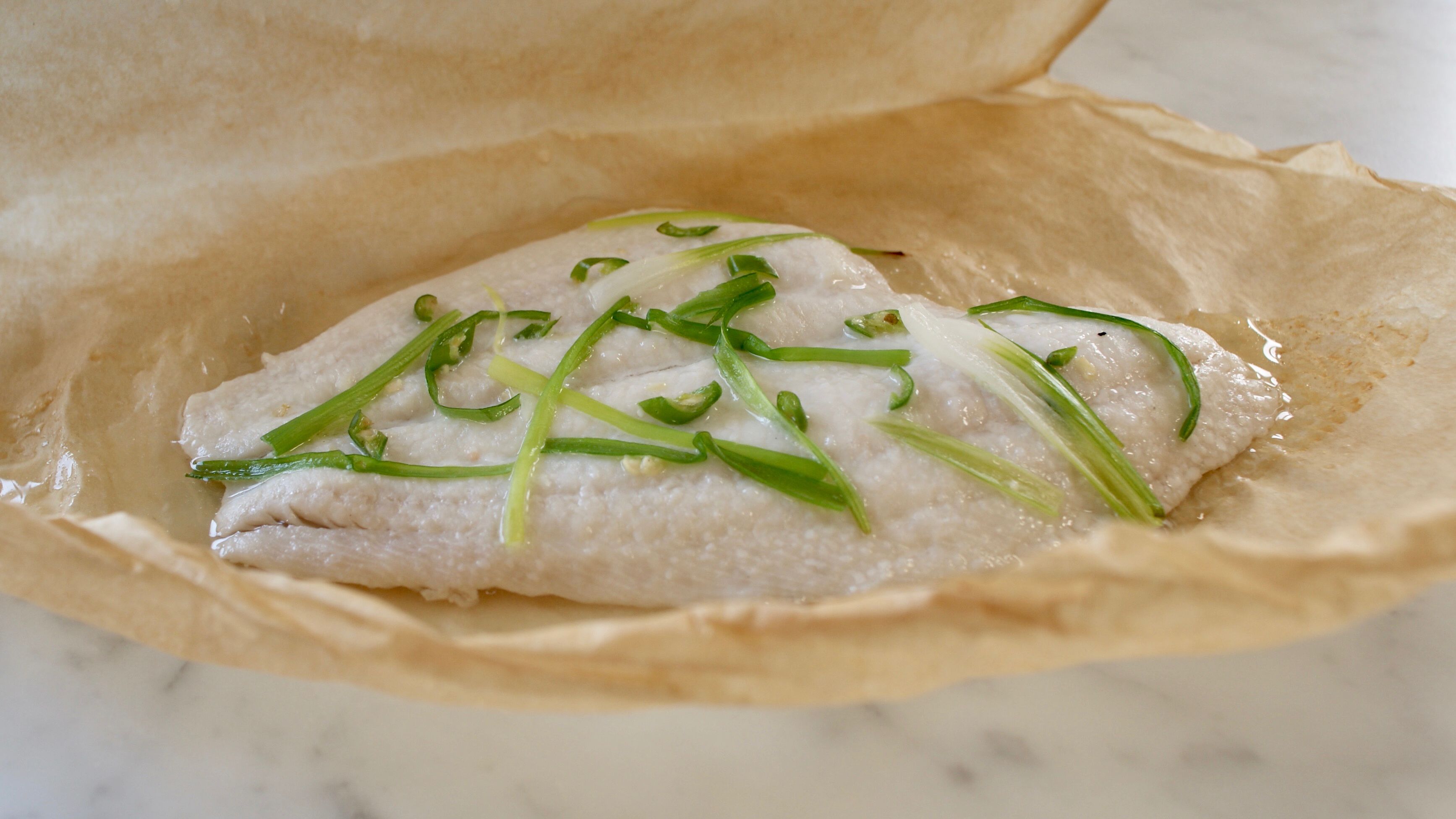 Is it better to bake fish on foil or parchment paper?