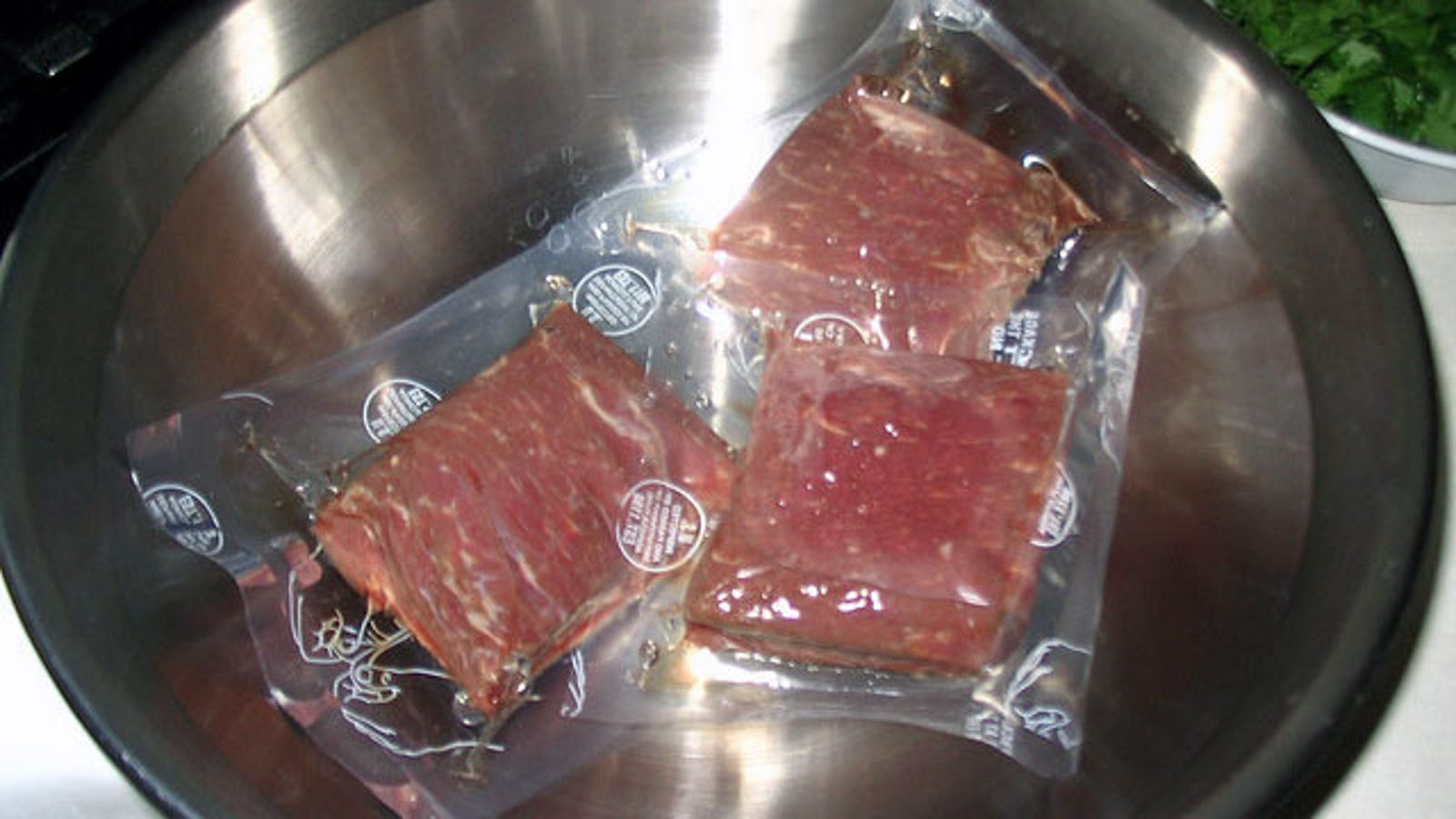 Is it better to defrost meat in cold or hot water?