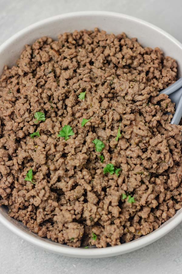 Is it better to season ground beef before or after cooking?